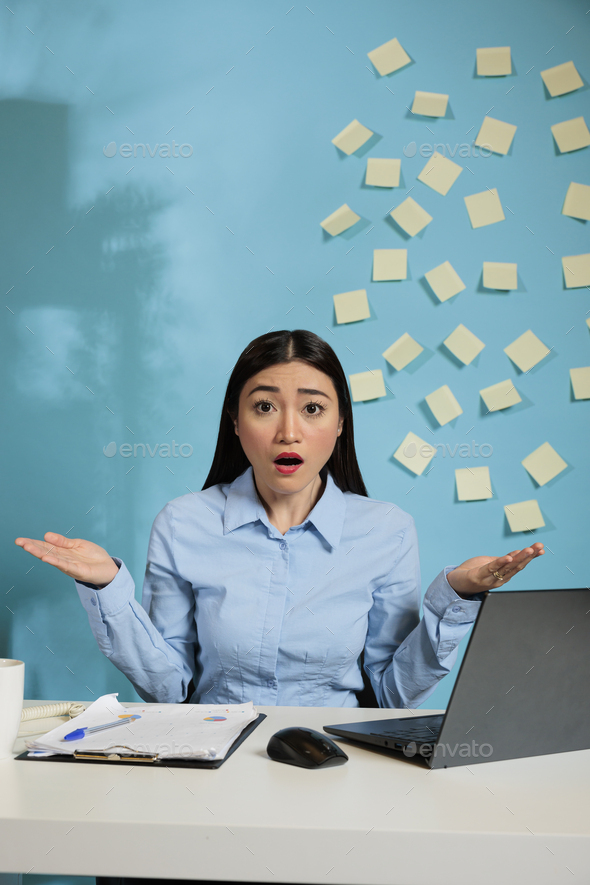 Female asian employee asking for explanation Stock Photo by DC_Studio