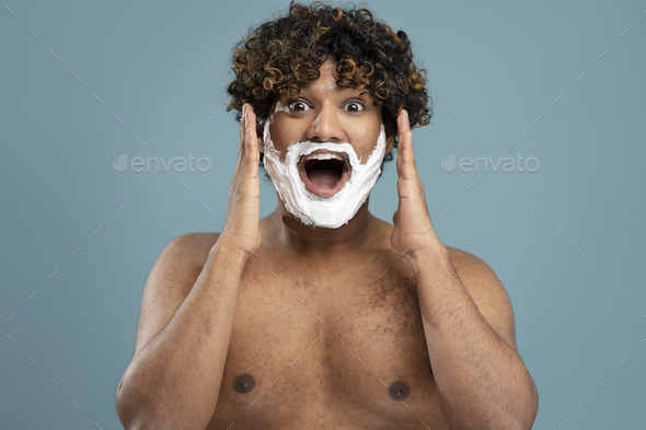 Shirtless Indian guy with shaving foam on his face, expressing ...