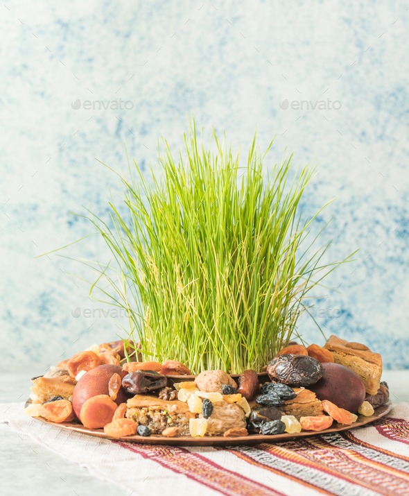 Novruz traditional tray with green wheat grass semeni or sabzi, sweets ...