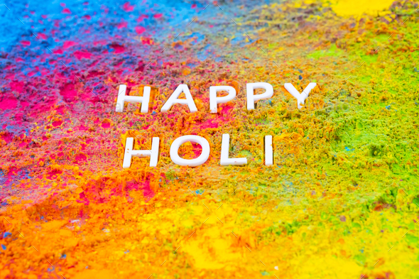Happy Holi word on holi powder paint background. Stock Photo by zhenny ...