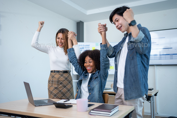 Group of creative young Asian business people happy, successful work ...