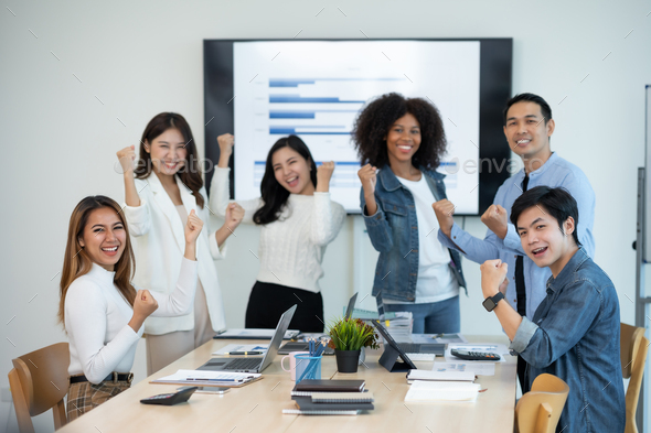 Group of creative young Asian business people happy, successful work ...