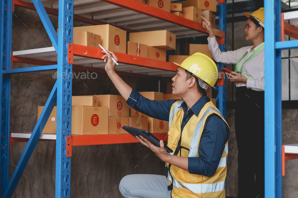 Asian male supervisor worker inspecting warehouse checking stock ...
