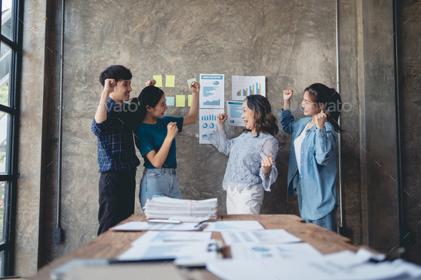 Group of creative young Asian business people happy, successful work ...