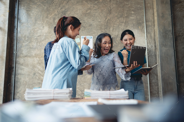 Group of creative young Asian business people happy, successful work ...