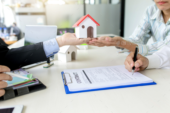 Signing a contract to buy a house, sell a house and making insurance a ...