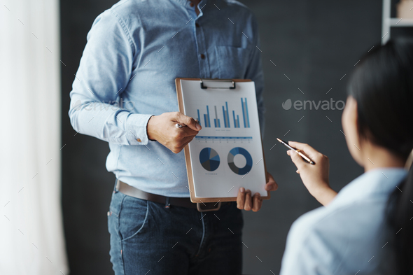 Group business people meet and discuss chart and point at chart Company ...