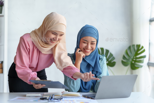 Two beautiful Muslim Asian businesswomen wearing hijab We are ...