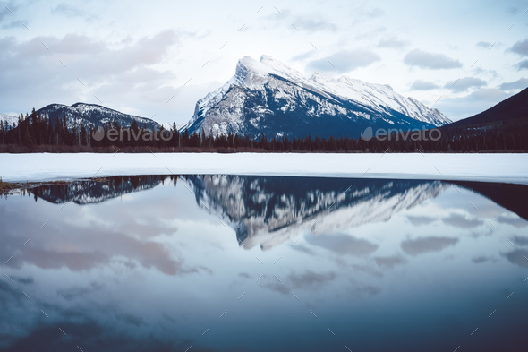 Beautiful shot of Mount Rundle Banff reflecting in the water in Canada ...