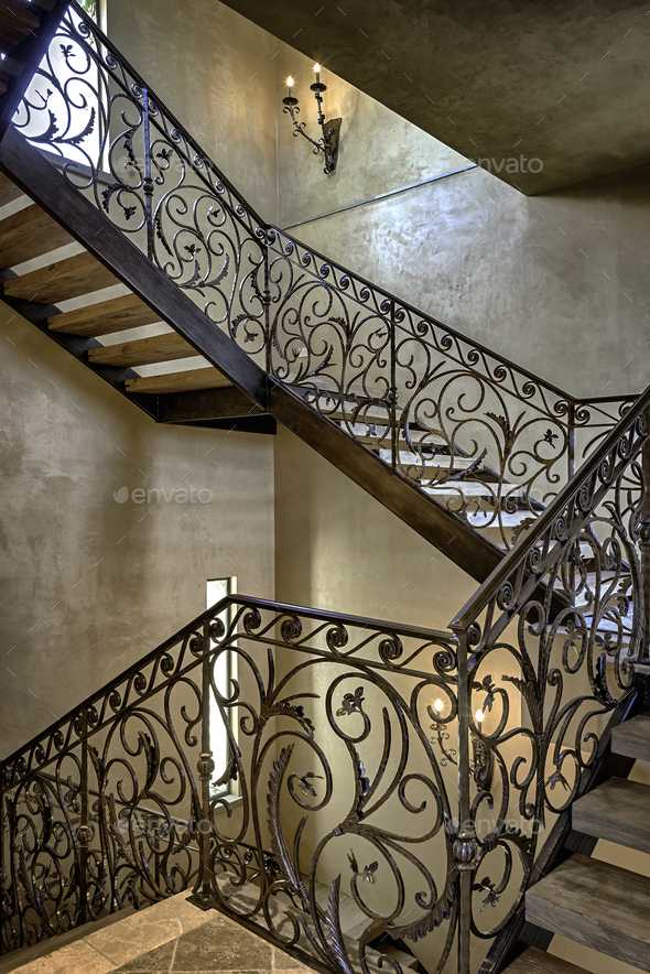 Vertical shot of a staircase with luxurious railings in a building ...