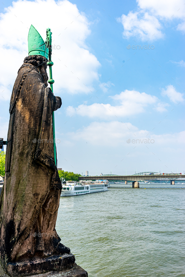 Statue of Saint Nicholas overlooking a river in Cologne Stock Photo by ...