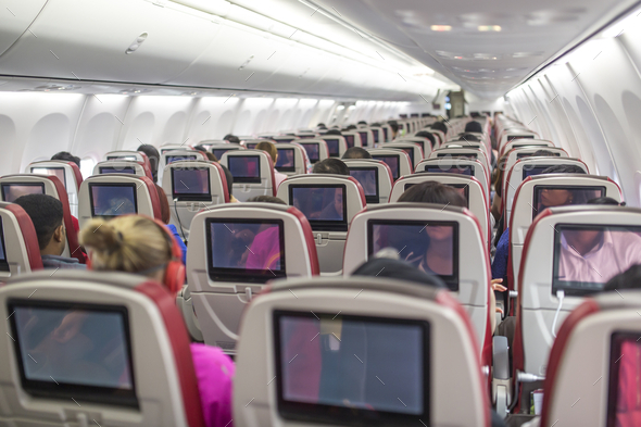 Passengers traveling by a new jet plane, shot from the inside of an ...