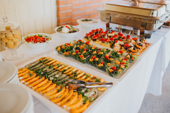 Sets of different food on a buffet table Stock Photo by wirestock ...