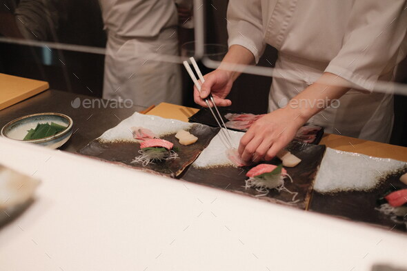 Chef making sushi in a Japanese restaurant Stock Photo by wirestock