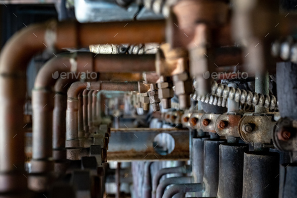 Weathered rusty refrigeration rack in a factory Stock Photo by wirestock