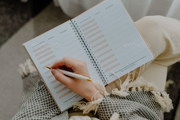 Top view of a female hand with pen writing notes in a journal Stock ...