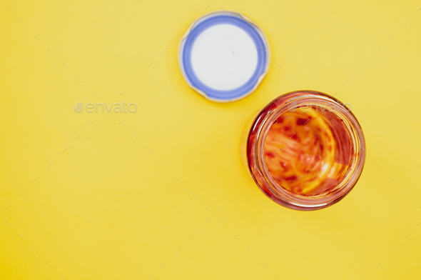 Top view of an open empty strawberry jam jar with lid isolated on light ...