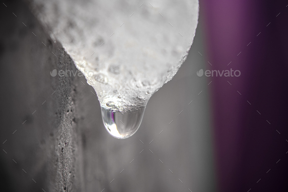 Selective focus shot of a water droplet falling from ice Stock Photo by ...