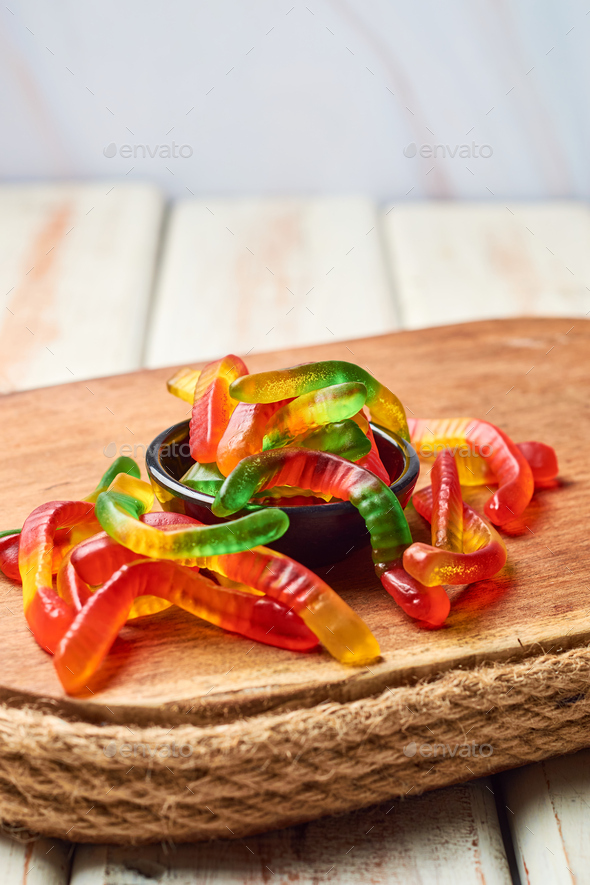 Colorful neon gummy worms candies in a bowl Stock Photo by FabianMontano