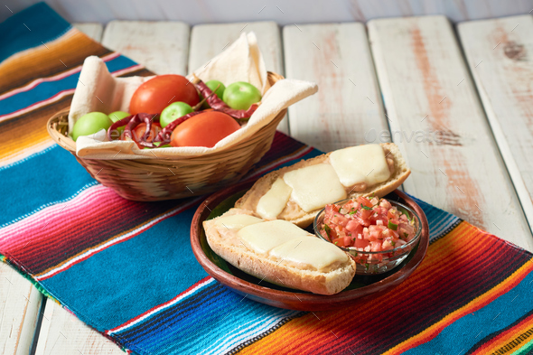 Molletes, typical Mexican food on a clay dish. Stock Photo by FabianMontano