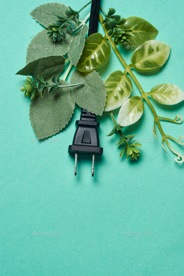 Electrical connection cable with green needles all around. Green energy ...