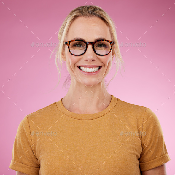 Portrait, smile and woman with glasses on pink background, studio and ...