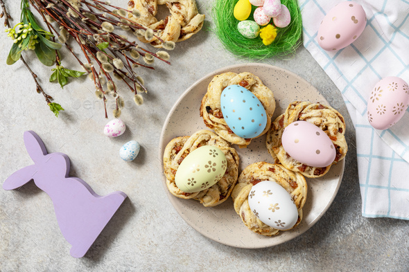 Sweet Italian Easter Bread Rings from puff pastry and dyed eggs on a ...