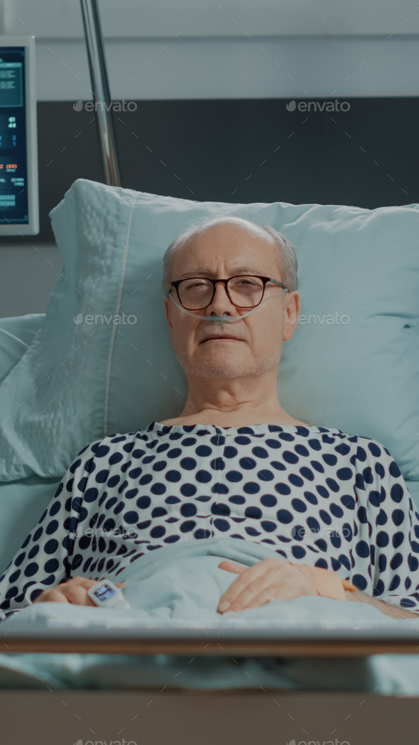Senior patient laying in hospital ward bed at healthcare unit Stock ...