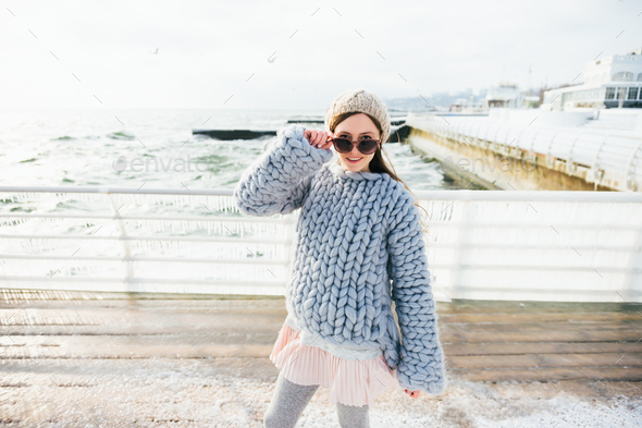 beautiful girl posing in merino wool sweater and sunglasses on winter ...