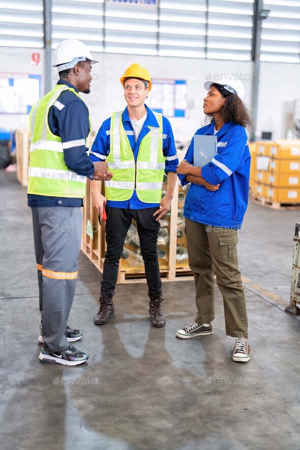 Warehouse worker standing talking discussion during break time in goods ...