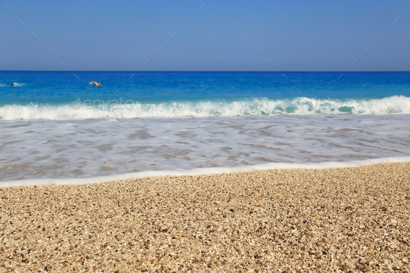 Sandy beach closeup with wave and blue sea Stock Photo by rawf8 | PhotoDune