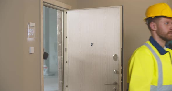 Diverse Builders Finishing Apartment Renovation and Leaving, Stock Footage