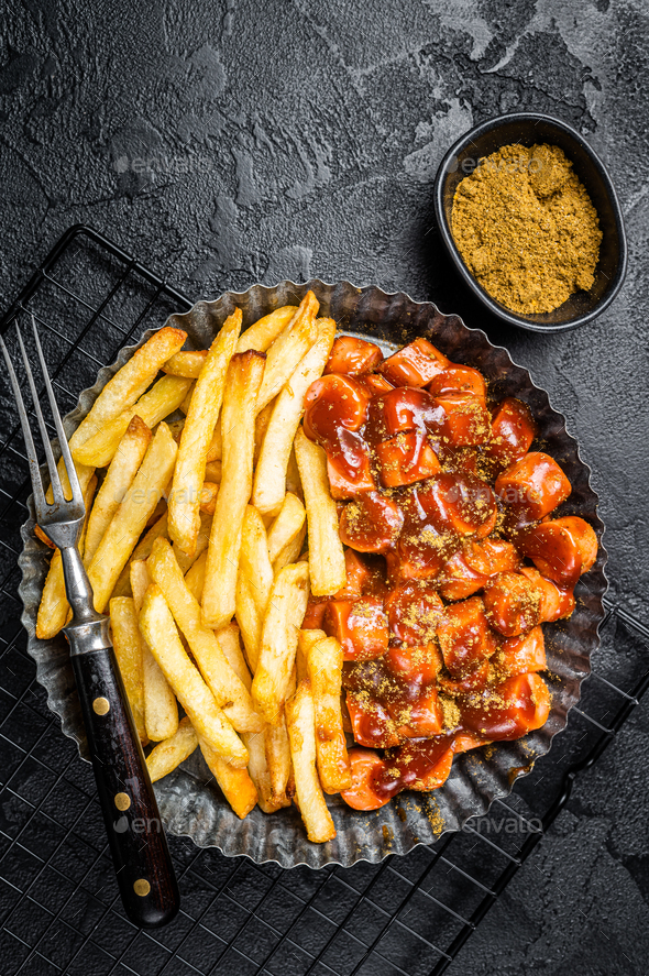 German fastfood currywurst meal, curry wurst with french fry. Black ...
