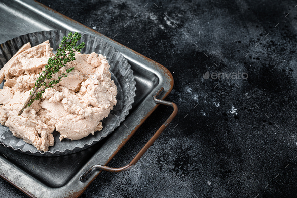 Canned Cod liver with thyme in oil on plate. Black background. Top view ...