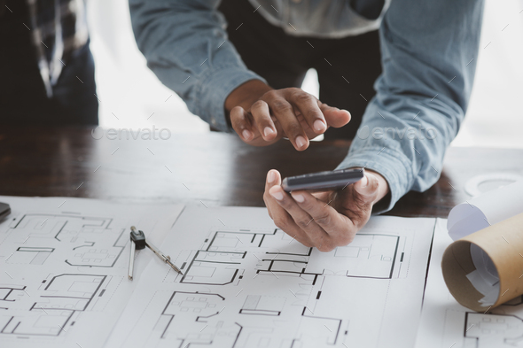 The home design architects are reviewing the house plan draft, the ...