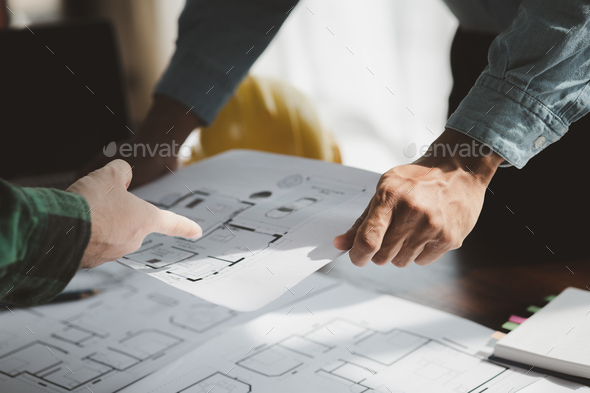 The home design architects are reviewing the house plan draft, the ...