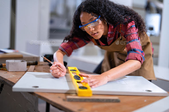 In work place carpenter man concentrate on ruler pencil draw alignment ...
