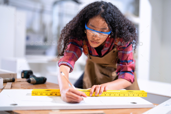 In work place carpenter man concentrate on ruler pencil draw alignment ...