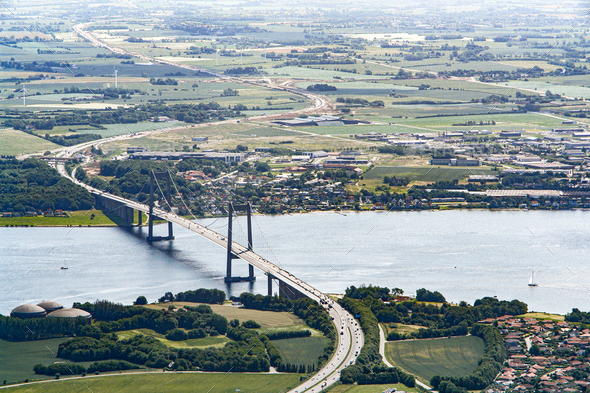 Aeral shot of a modern bridge crossing the river and connecting two ...