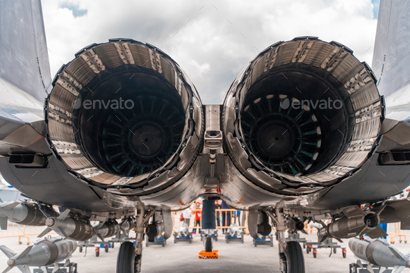 Back view of the giant powerful round engines of a military fighter jet ...