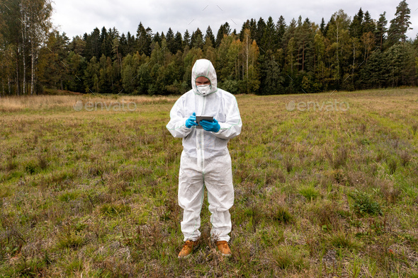person in Hazmat Suit analyzing a contaminated field Stock Photo by ...