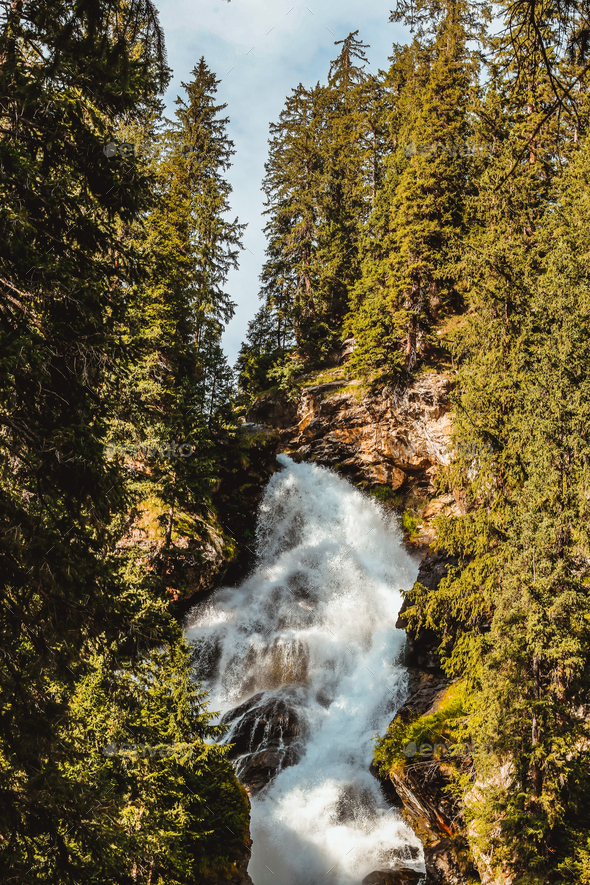 Vertical shot of rushing water from a waterfall in Kumrat Valley ...