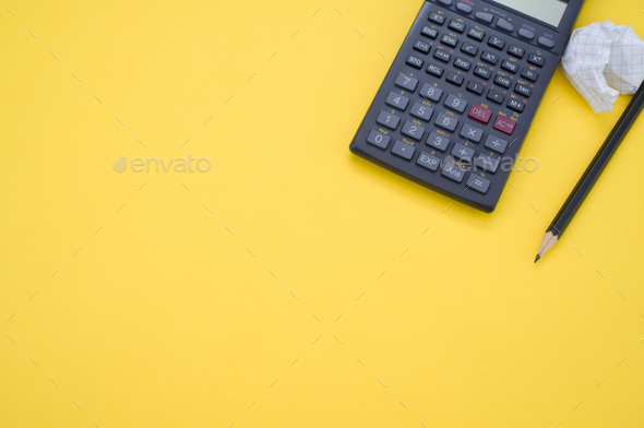 Scientific calculator, pencil, and a crumpled paper isolated on a ...