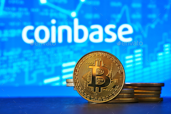Coinbase logo on a computer screen with a stack of crypto coins Stock ...
