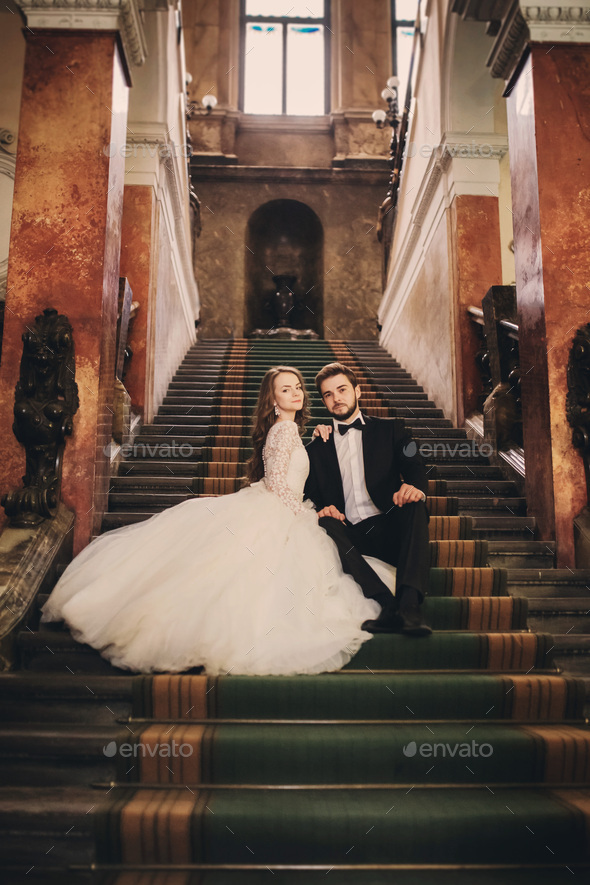 Beautiful newlyweds hugging on stairs the ancient house. Wedding ...