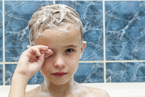 Adorable baby boy with shampoo soap suds on hair taking bath. Stock ...