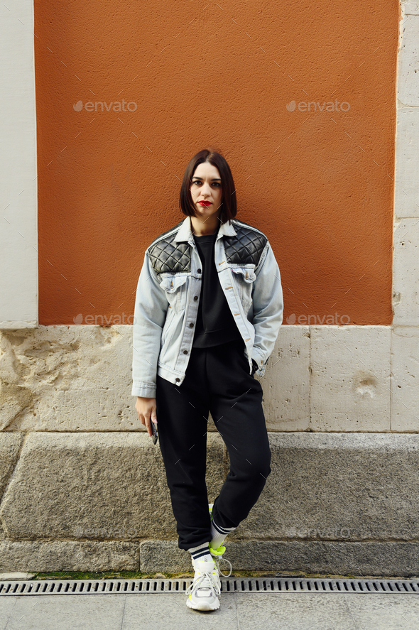 Young Spanish female with a bob style haircut wearing a bomber denim ...