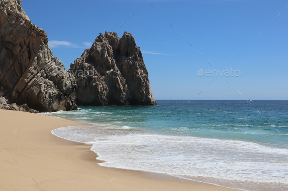 Pacific ocean and beach with golden sands and limestone rock formations ...