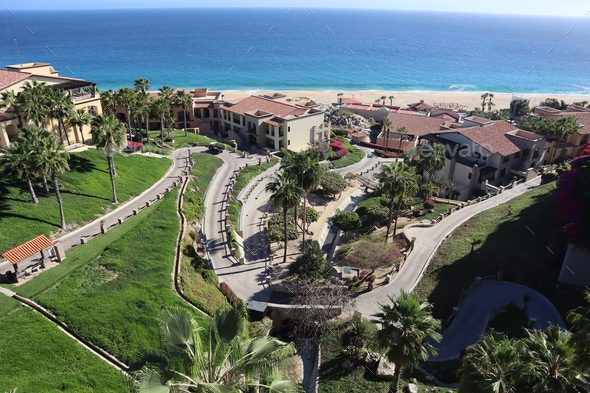 High angle view across the pathways of an oceanside with luxury resorts ...