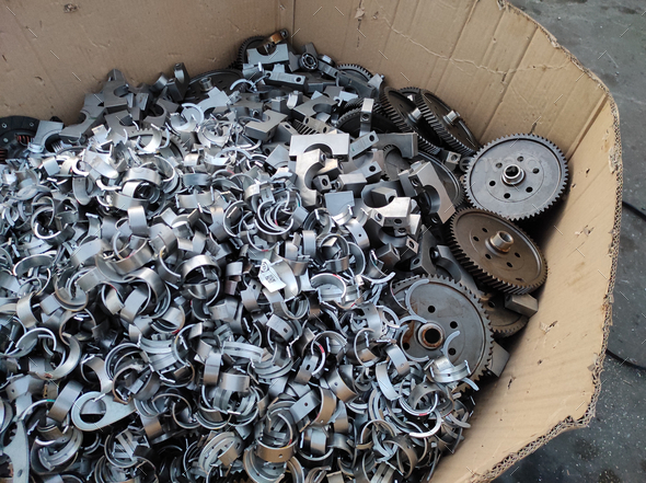 Heap of aluminum scrap in a cardboard box Stock Photo by wirestock